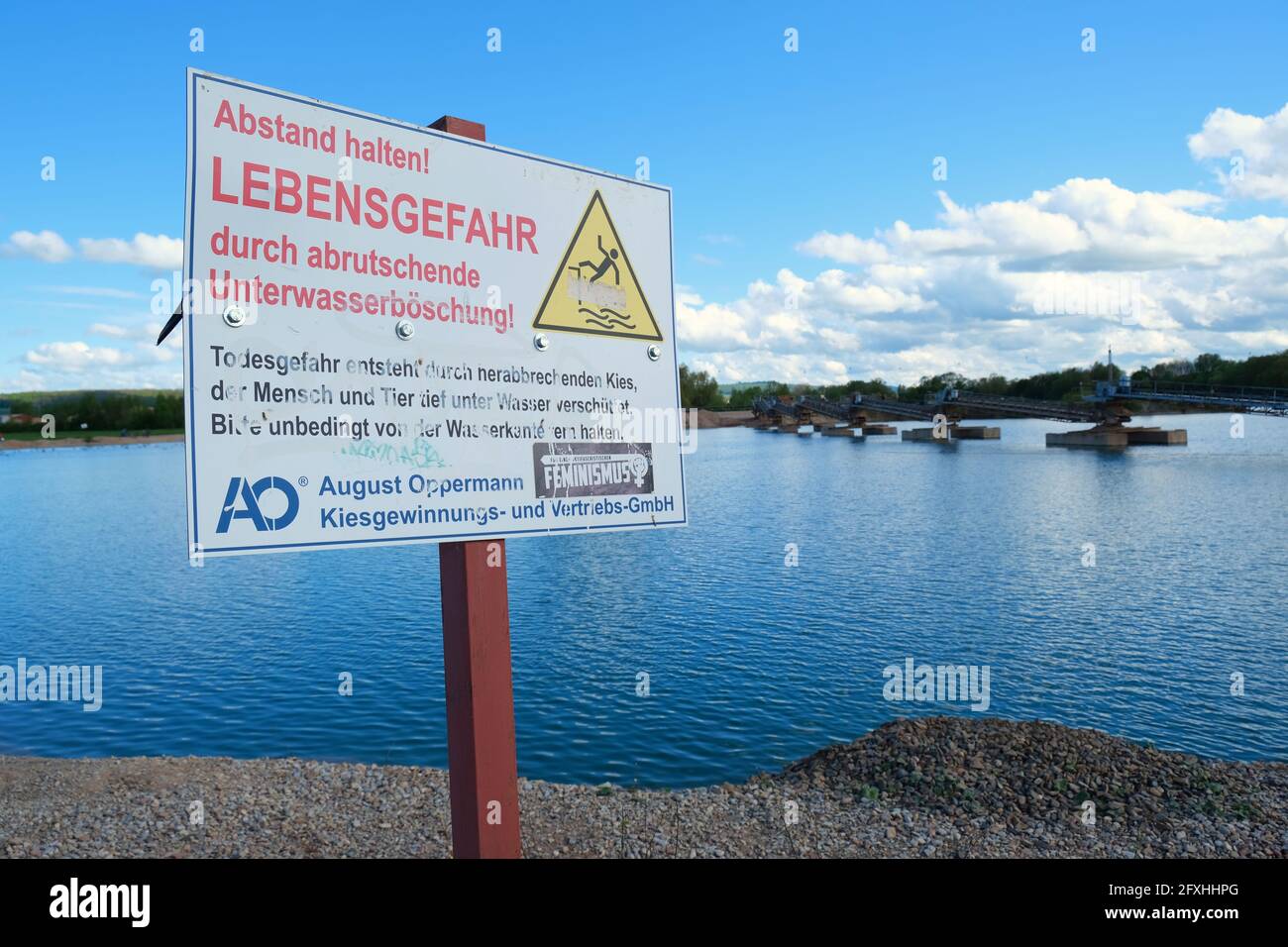 German warning sign at a quarry lake with Industrial equipment Stock ...