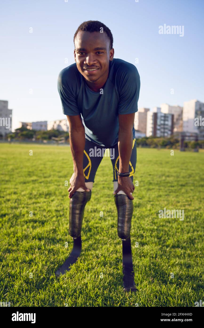 Portrait confident handsome male amputee athlete in grass Stock Photo ...