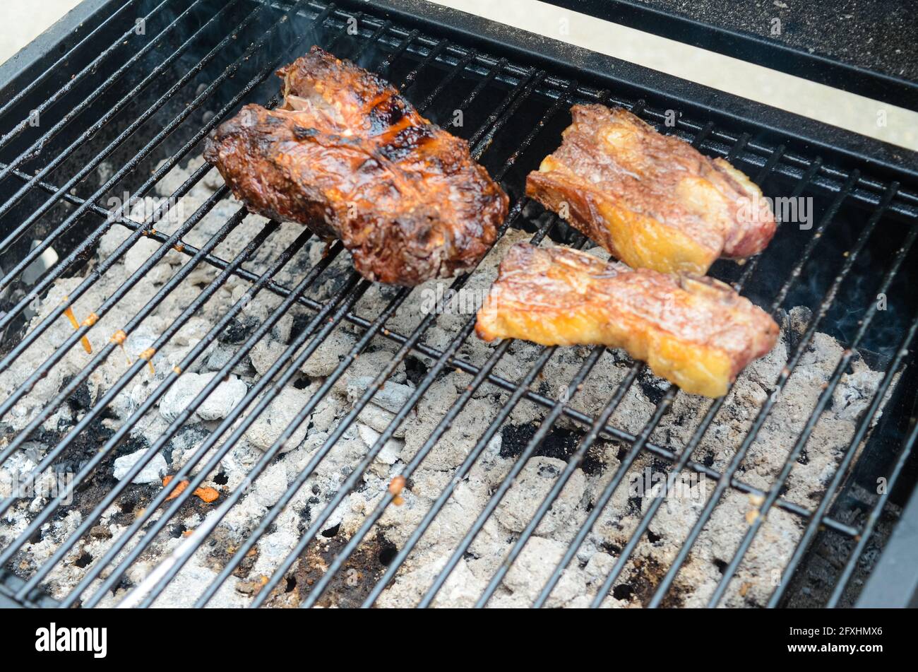 Top view of traditional Argentinian Asado, meat cooking on the grill at ...