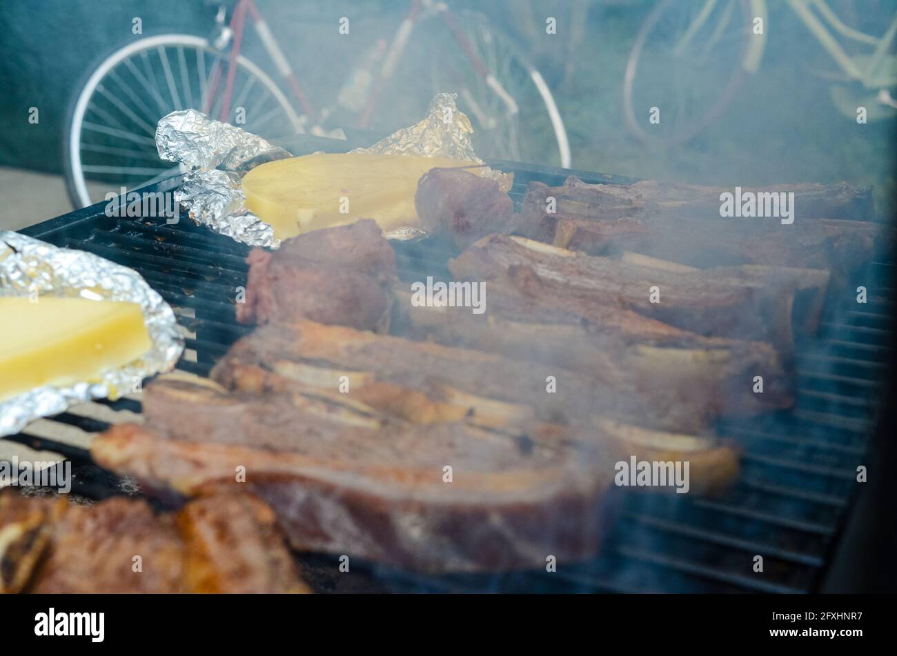 Closeup shot of provolone cheese and meat cooking on the grill at a ...
