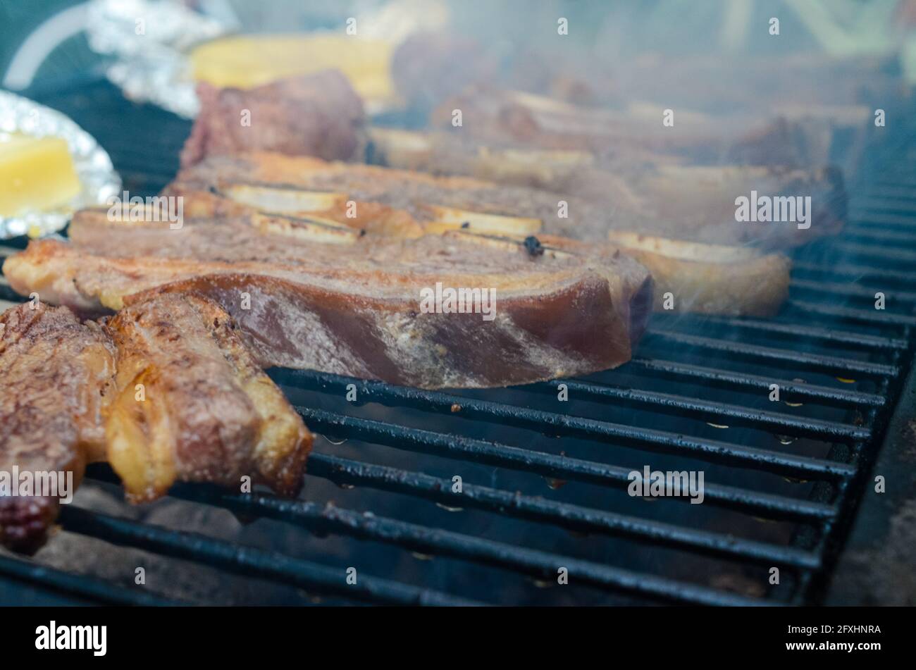 Closeup shot of traditional Argentinian Asado, meat cooking on the ...