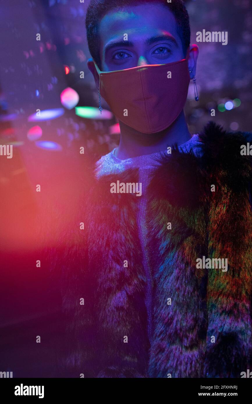 Portrait stylish young man wearing face mask in nightclub Stock Photo ...
