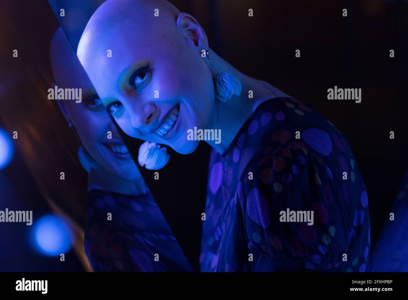 Portrait beautiful woman with shaved head in blue neon light Stock ...