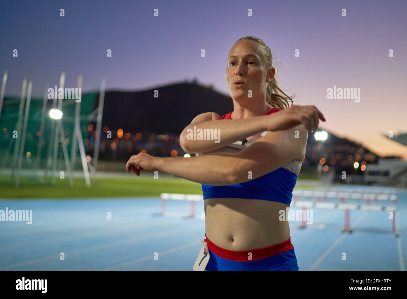 Female track and field athlete preparing for competition on track Stock ...