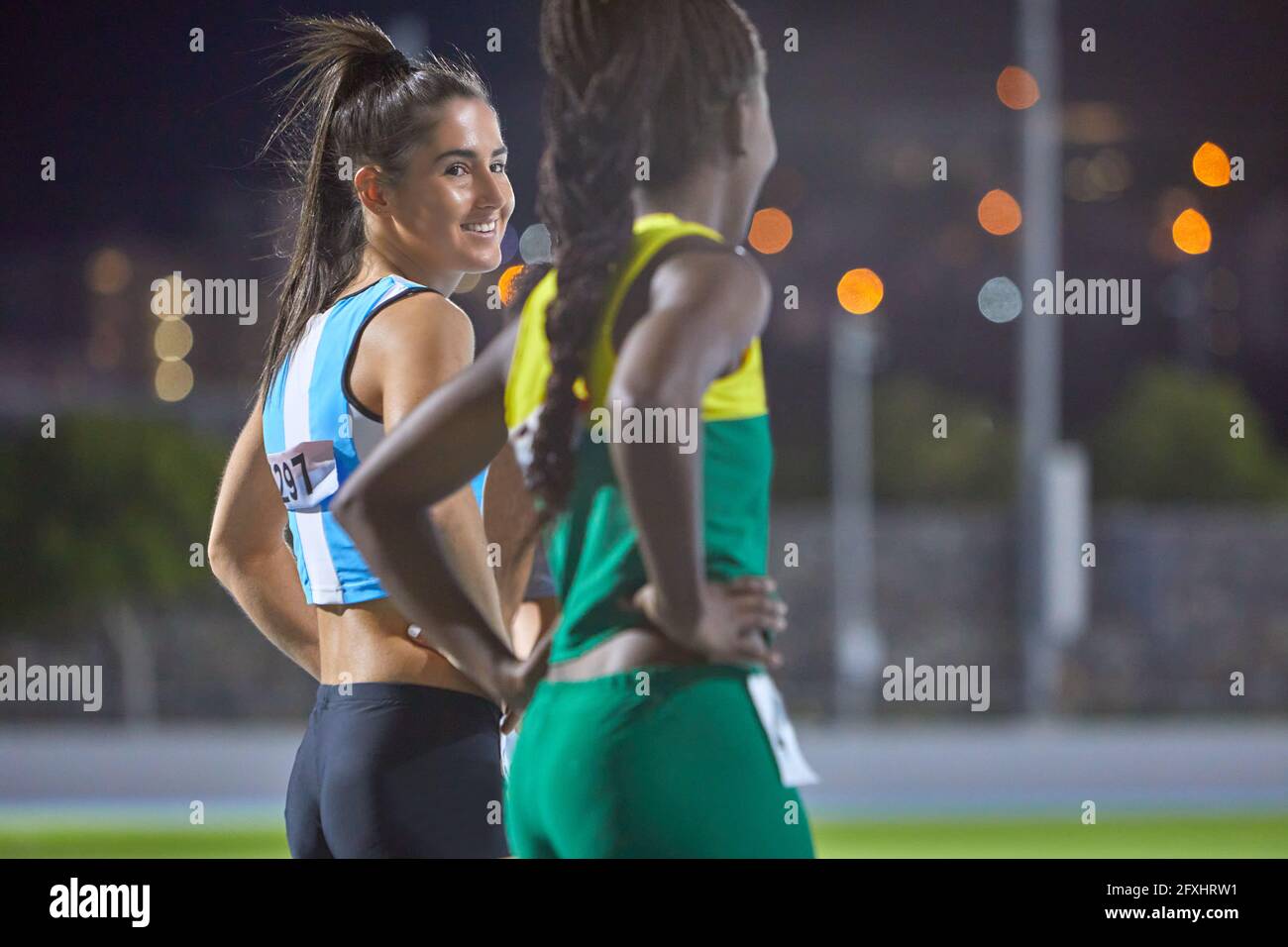 Happy female track and field athletes at competition Stock Photo - Alamy