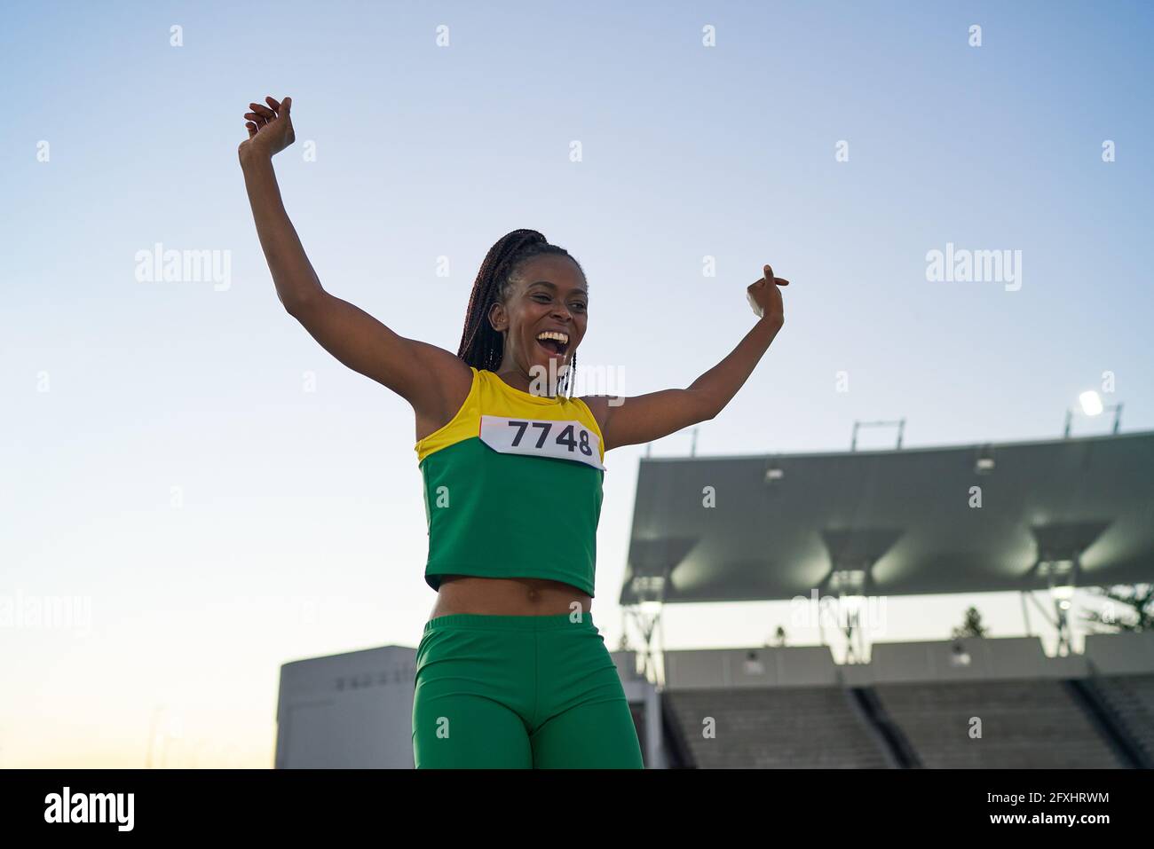 Happy female track and field athlete celebrating at competition Stock ...