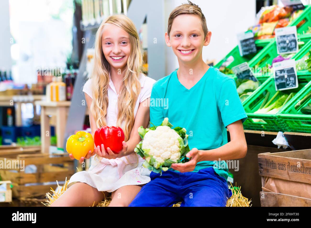 Children selecting vegetables while organic grocery shopping in ...