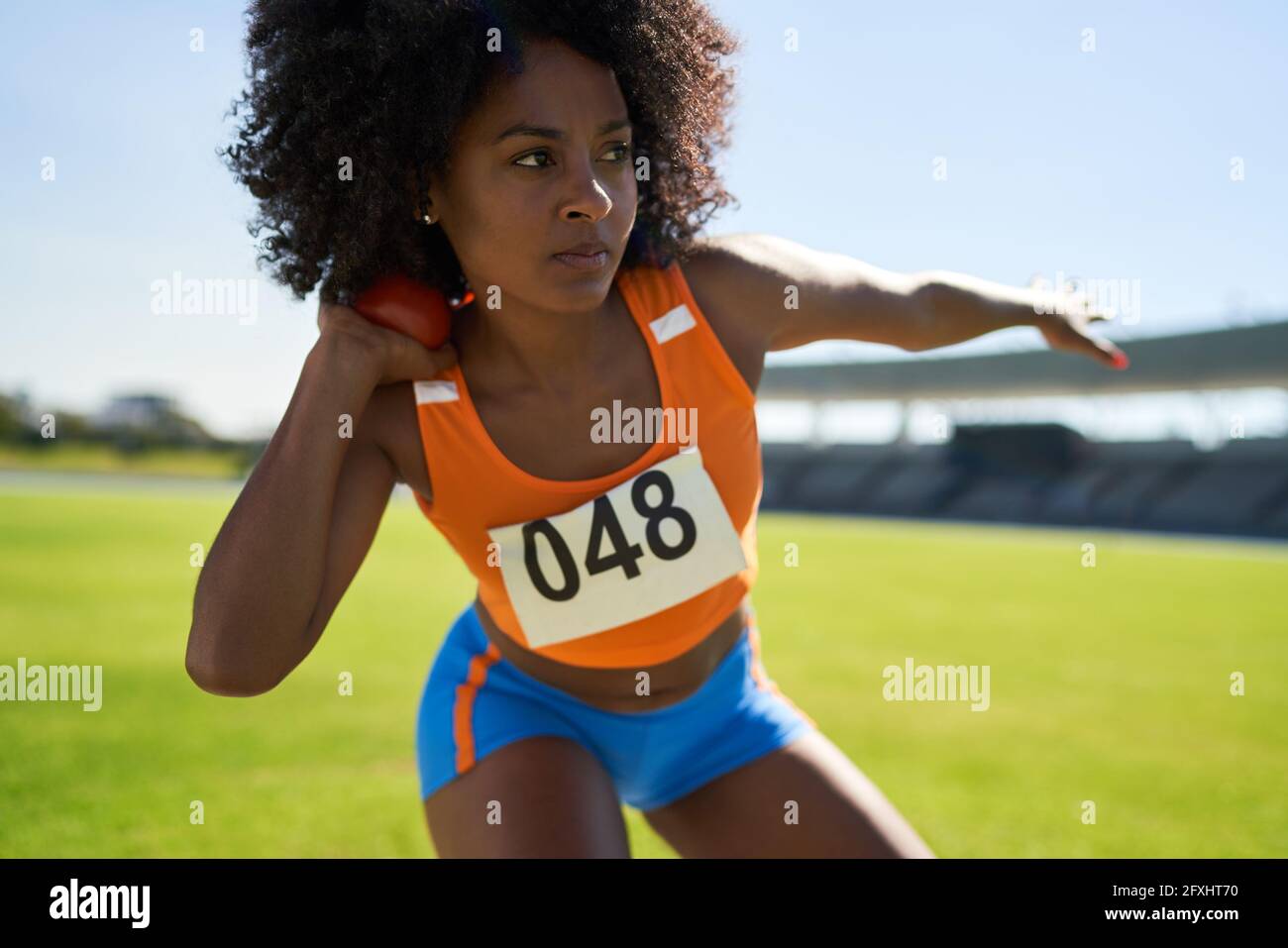 Focused female track and field athlete throwing shot put Stock Photo - Alamy