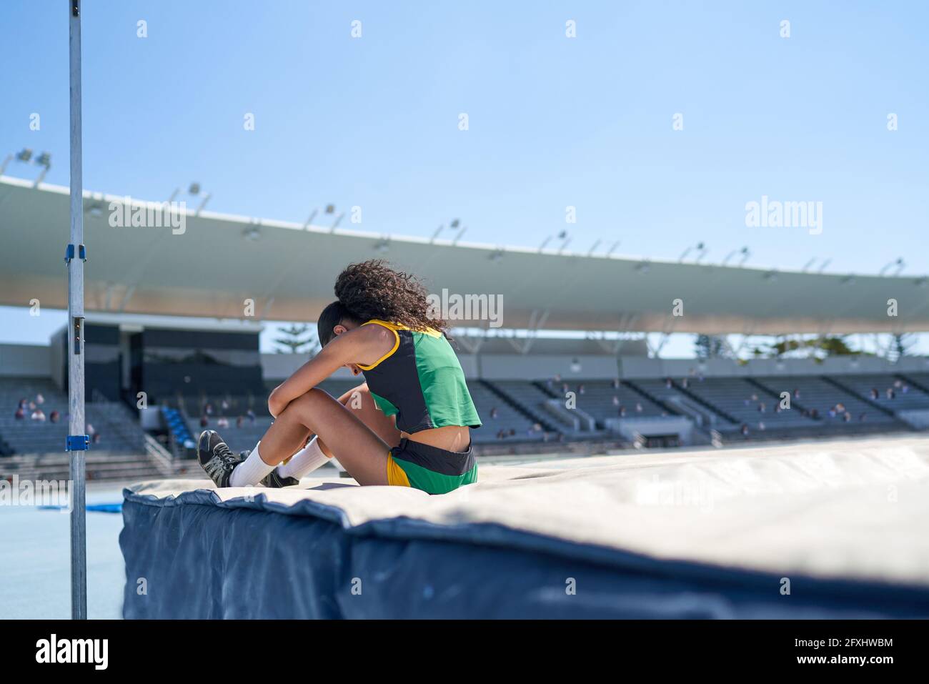 Female track and field high jumper in sunny stadium Stock Photo - Alamy