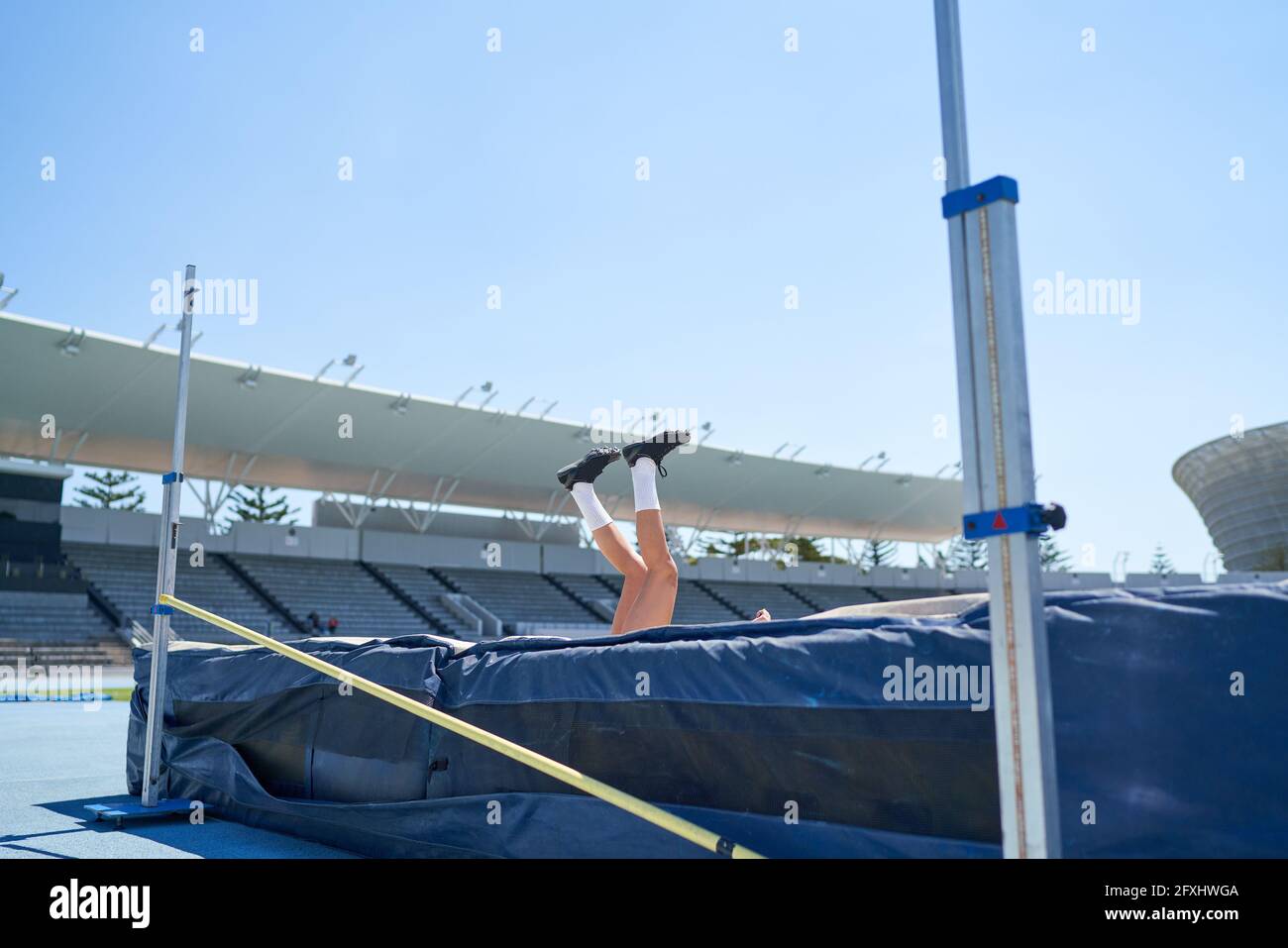 Female track and field athlete falling over high jump Stock Photo - Alamy