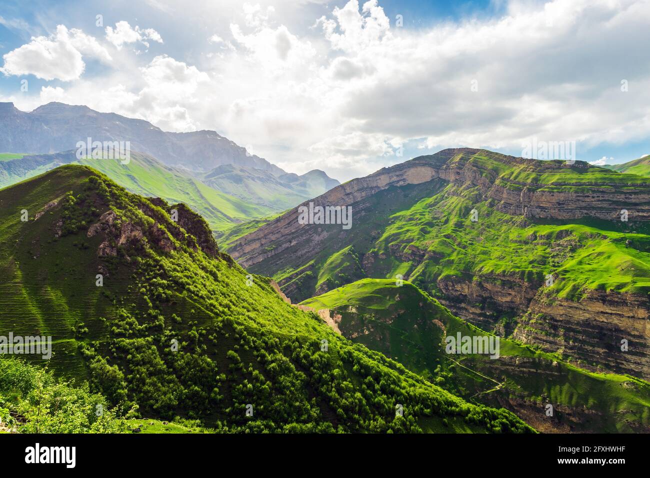 Green mountains and blue clouds landscape Stock Photo - Alamy