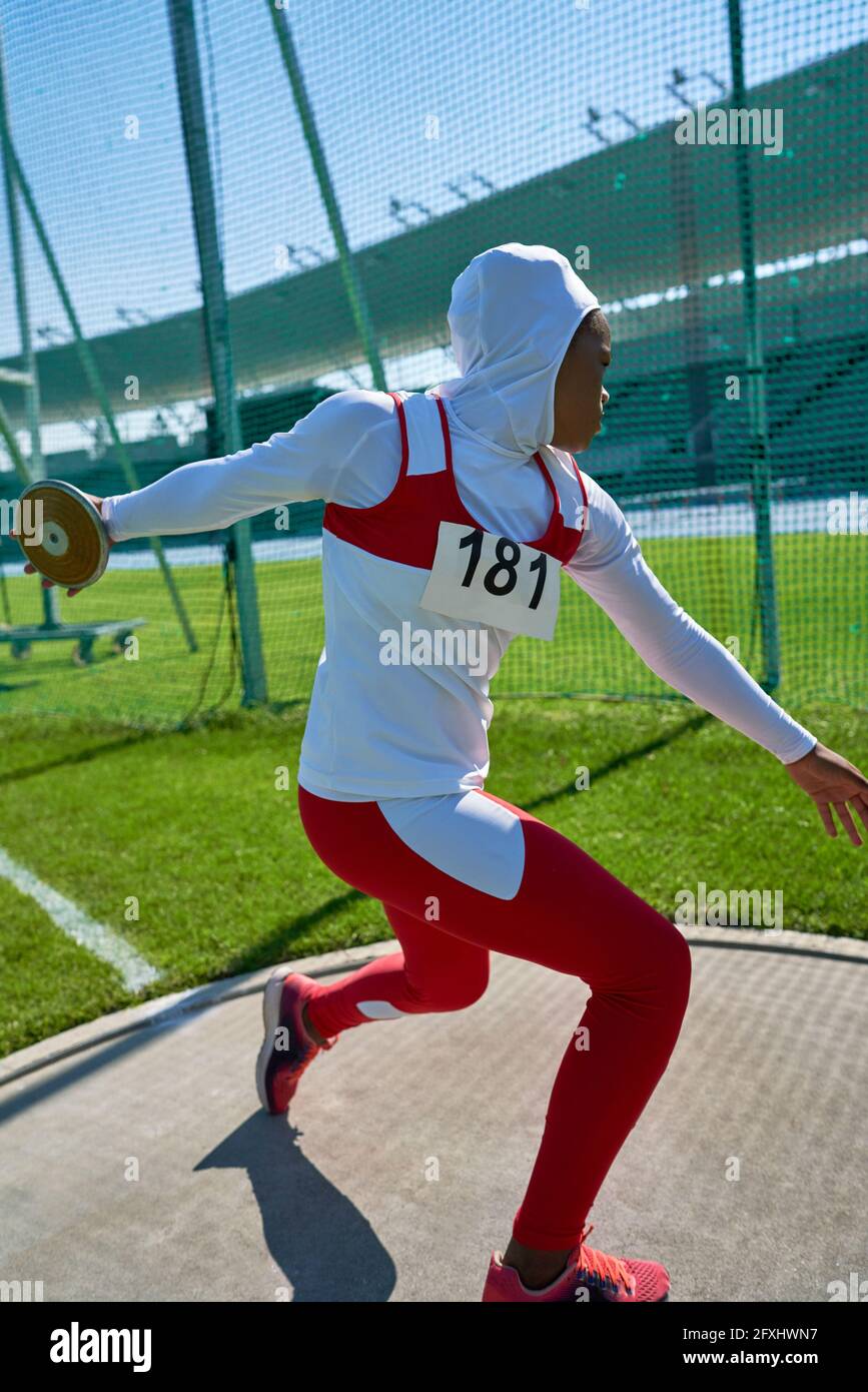 Female track and field athlete in hijab throwing discus Stock Photo - Alamy