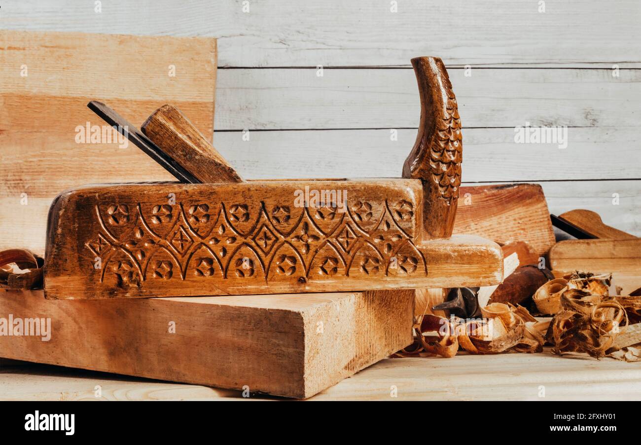 Photo of wooden old fashioned carved planes laying on workbench table ...