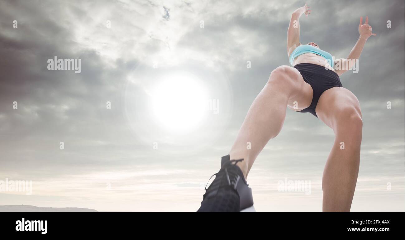 Composition of caucasian female high jumper in the air with copy space ...