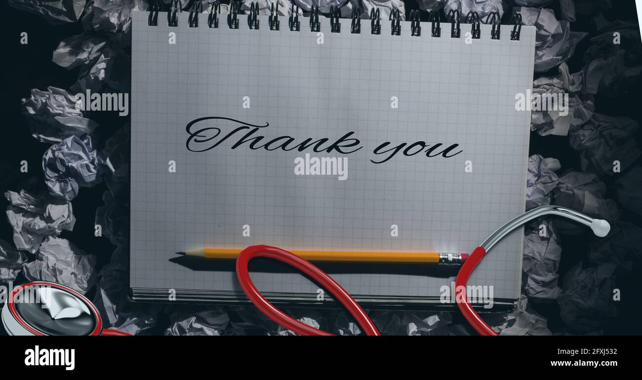 Composition of notebook with thank you note and scrunched paper, pencil ...