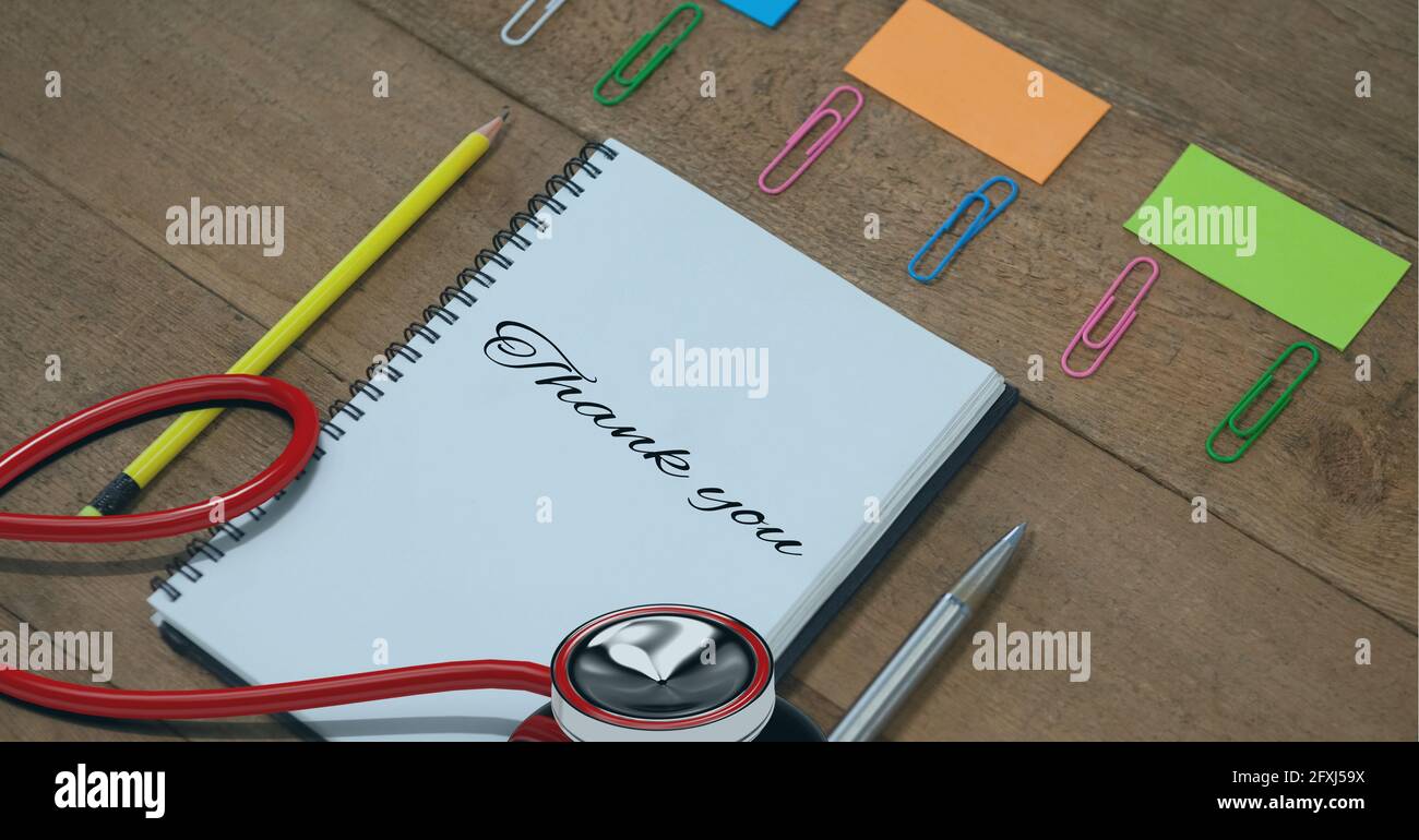 Composition of notebook with thank you note, with stethoscope and ...