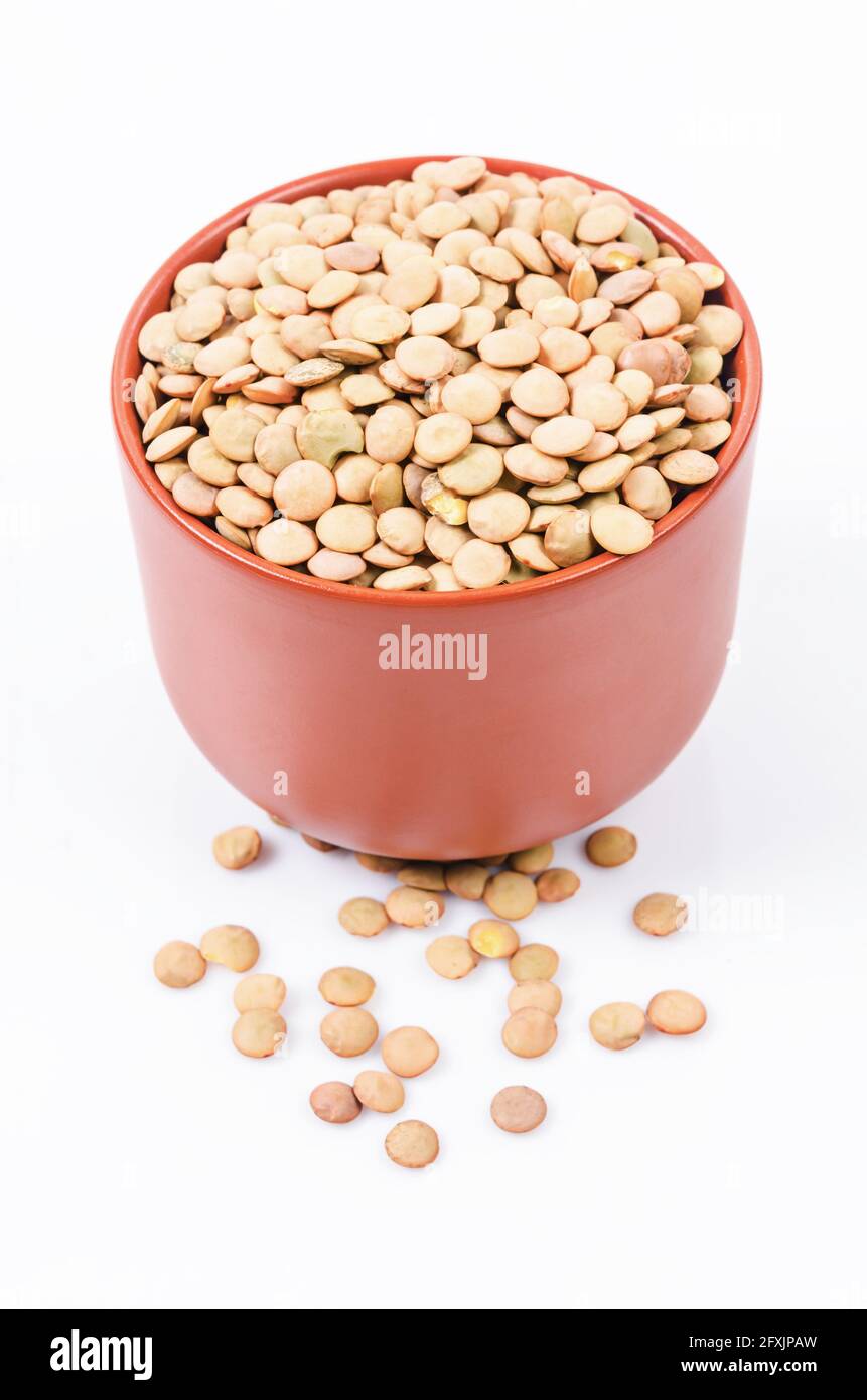 Brown Lentils in cup on white background Stock Photo - Alamy