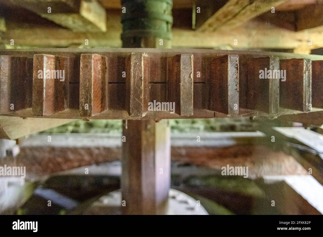 Close up of a wooden cogwheel seen in the old colonial mill. Black ...