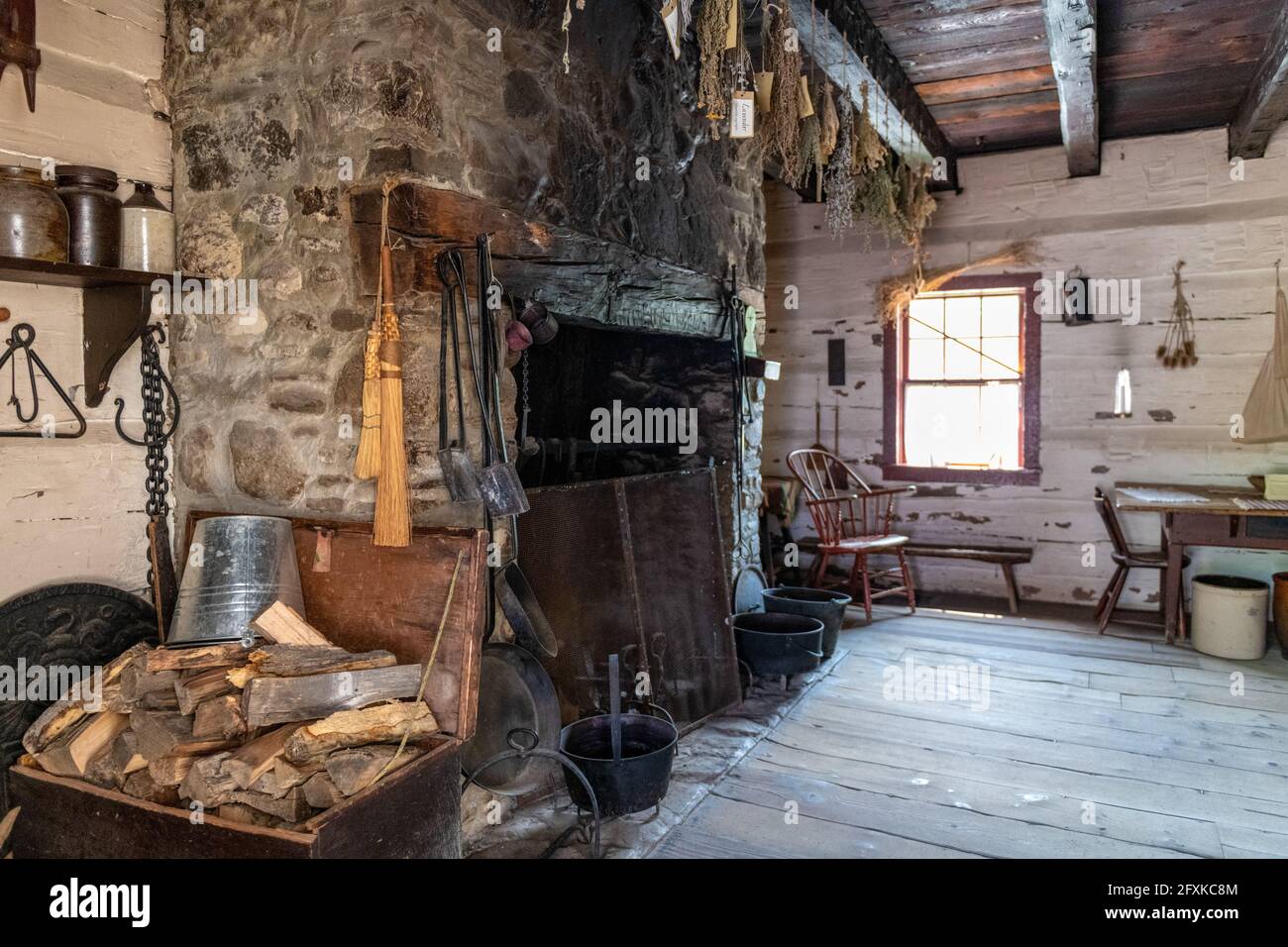 An old room with a fireplace and the typical objects of the Canadian ...