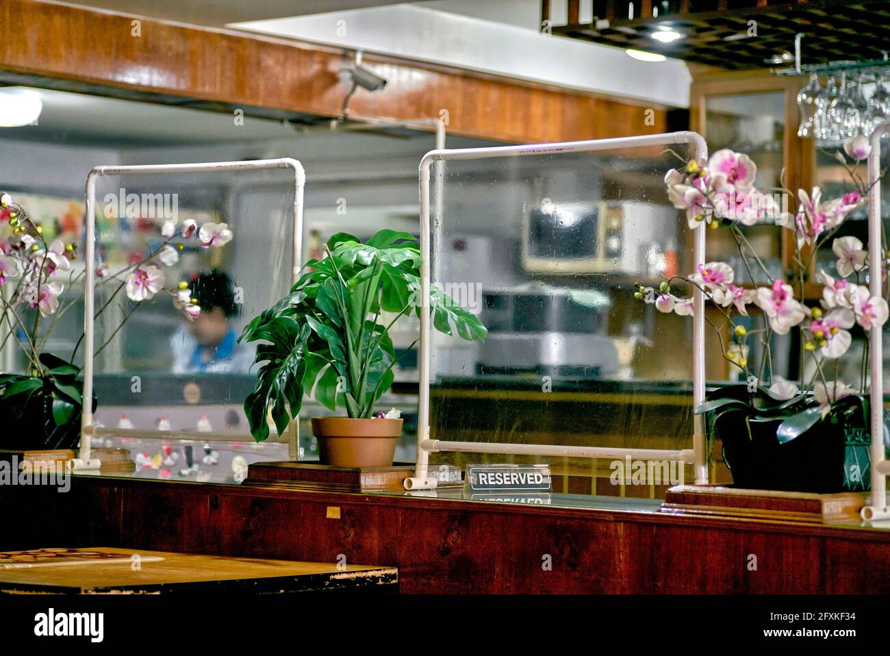 Plexiglass screen installed in a restaurant for the protection of staff ...