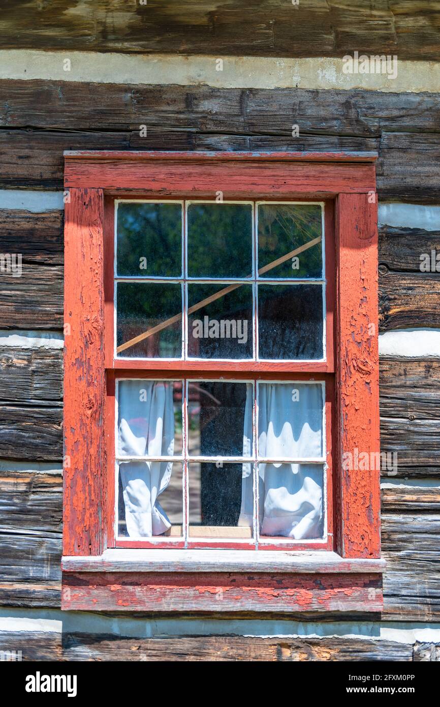 Colonial style window in a wooden house. Black Creek Pioneer Village is ...