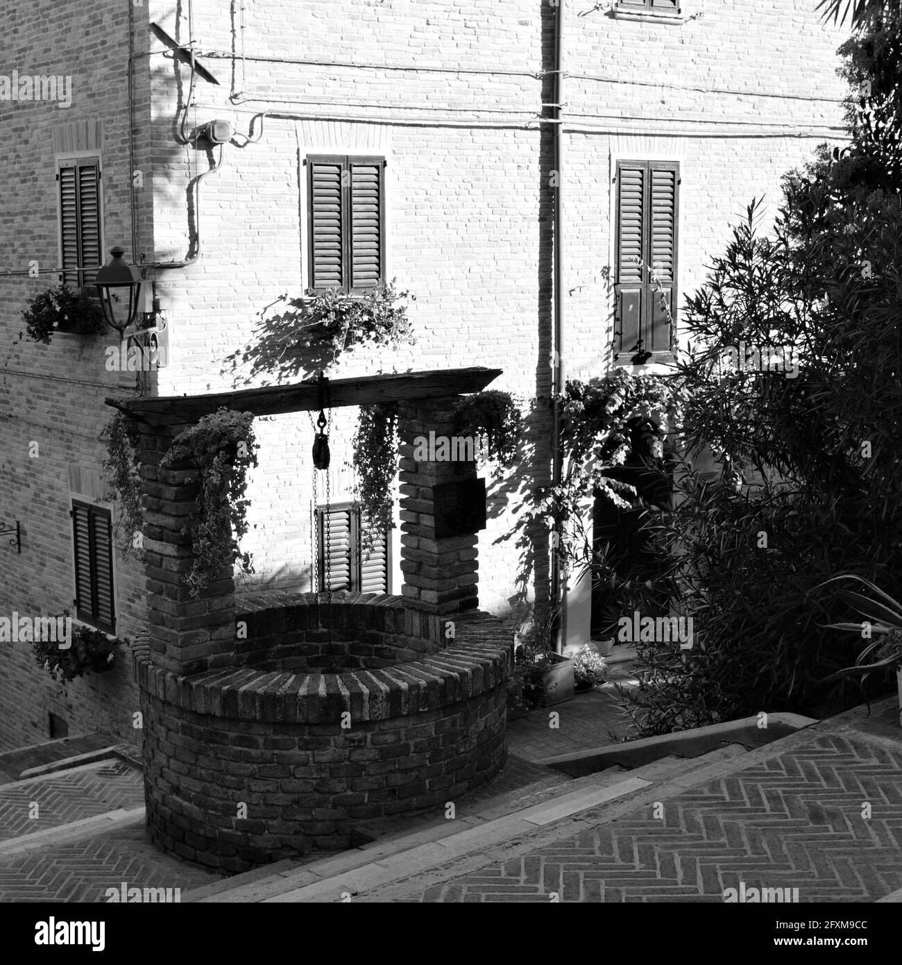 A medieval brick water well in the middle of a staircase in an ancient ...