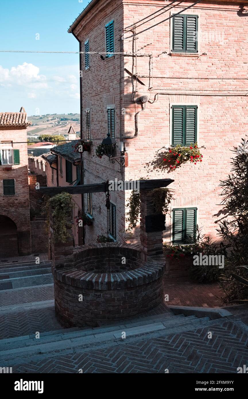 A medieval brick water well in the middle of a staircase in an ancient ...