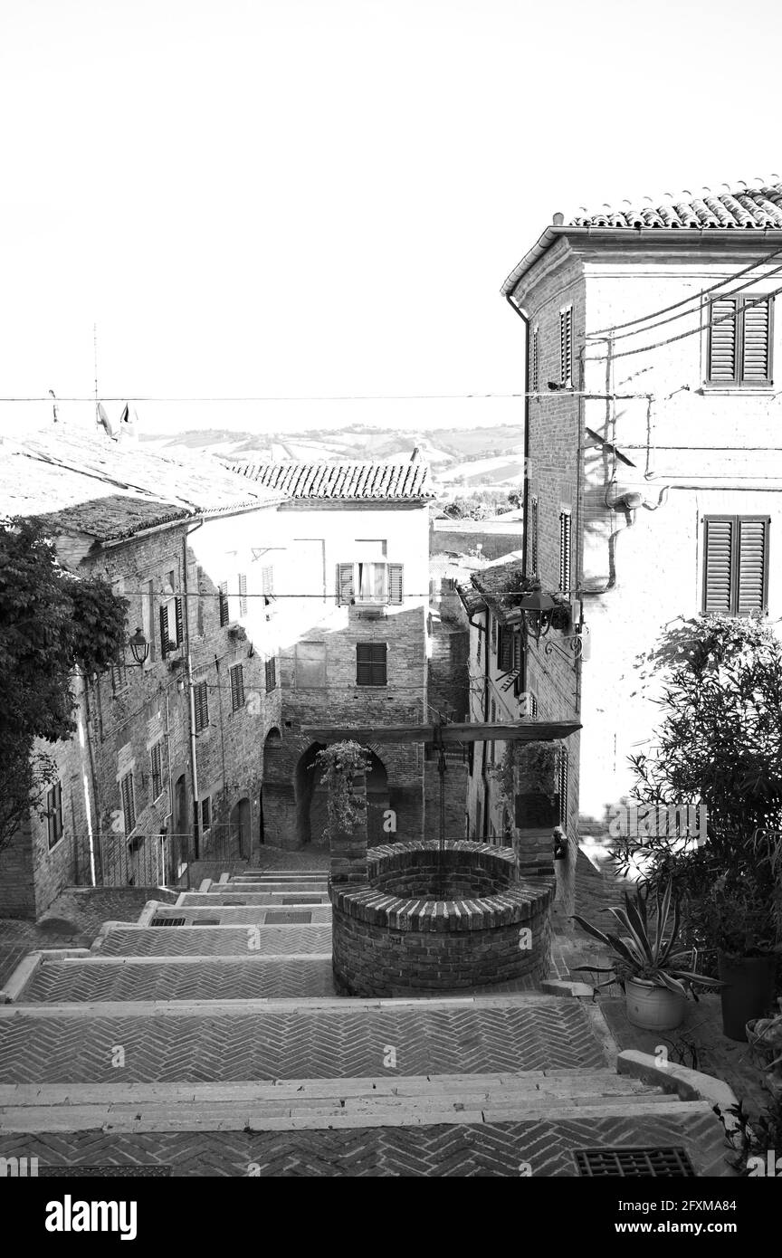 A medieval brick water well in the middle of a staircase in an ancient ...