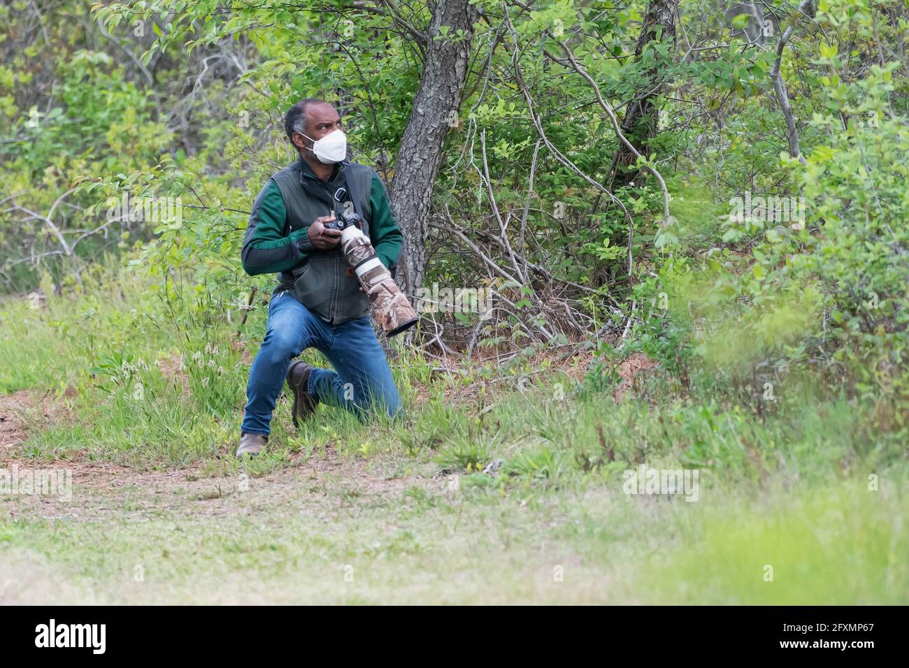 ,Bird photographer at the Jamaica Bay Wildlife refuge wearing mask ...
