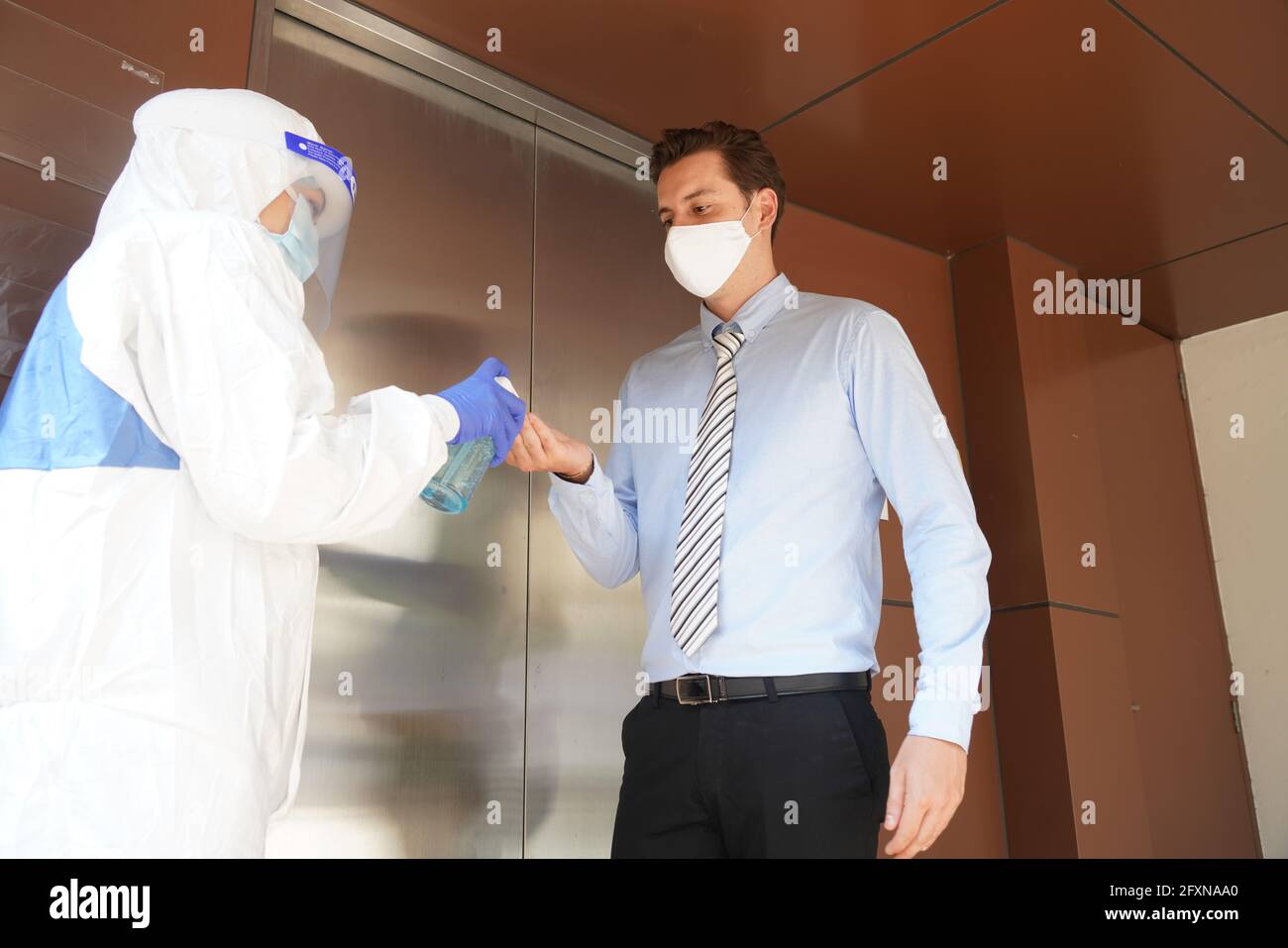 Disease control experts use an Infrared thermometer equipment to check ...