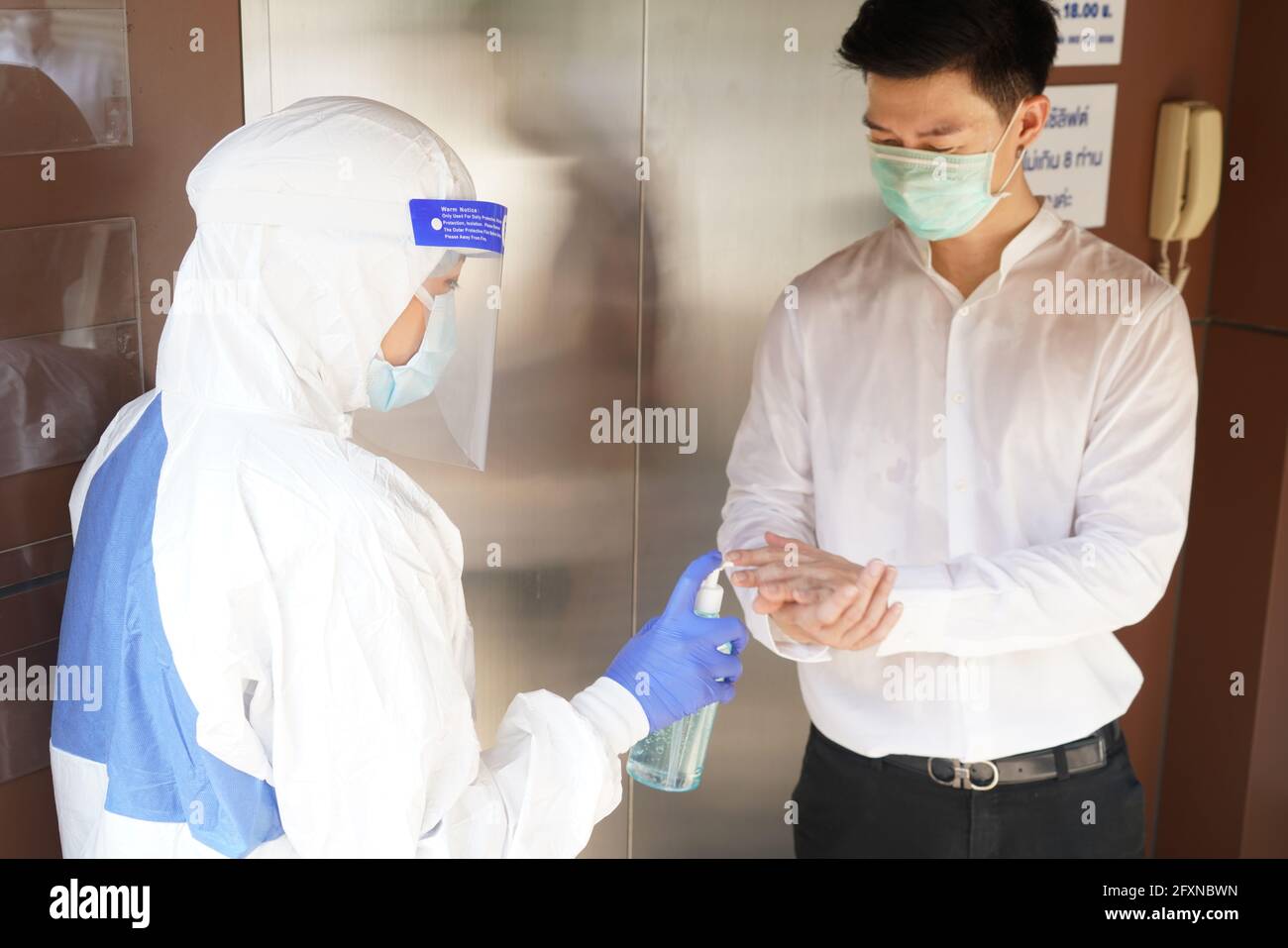Disease control experts use an Infrared thermometer equipment to check ...