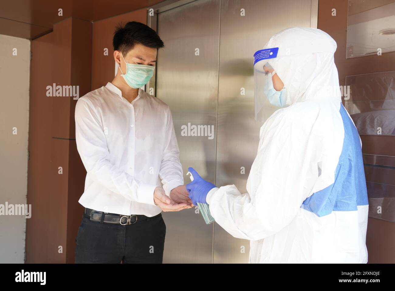Disease control experts use an Infrared thermometer equipment to check ...