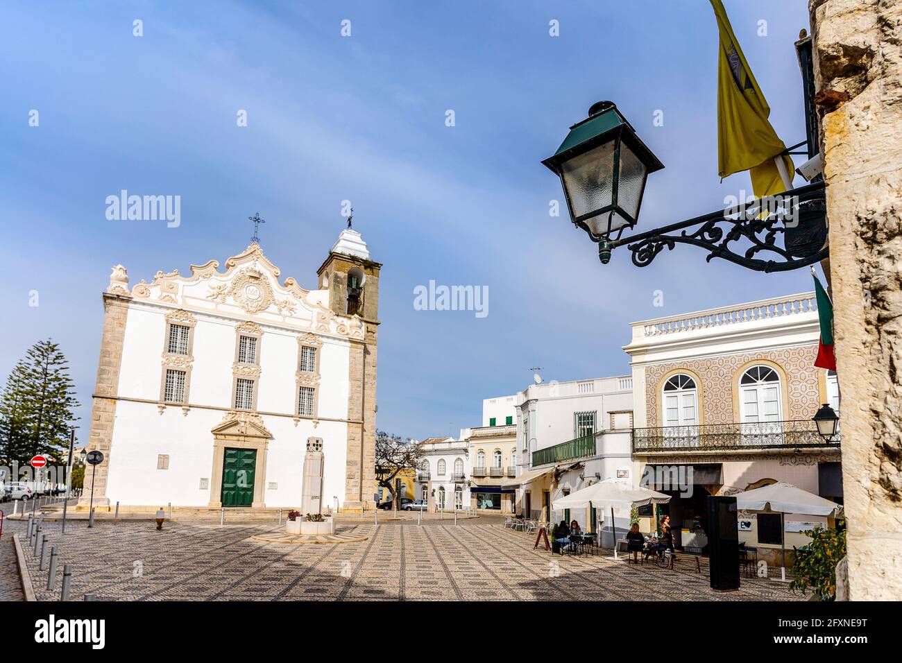 Square with white, old church and monument in Olhao, Algarve, Portugal ...
