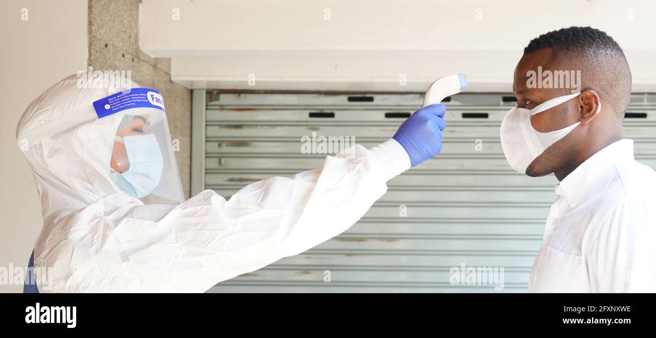 Disease control experts use an Infrared thermometer equipment to check ...