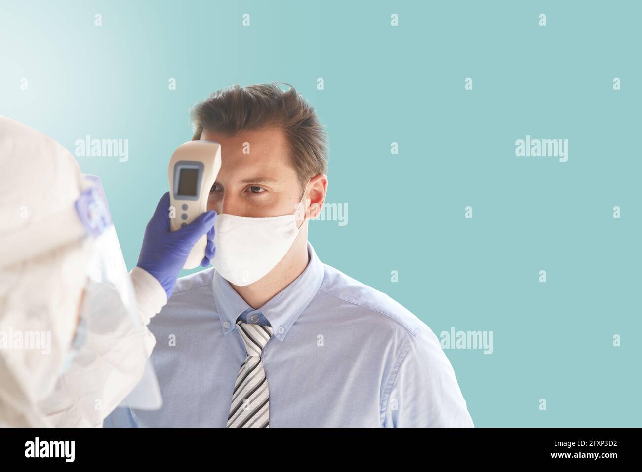 Disease control experts use an Infrared thermometer equipment to check ...