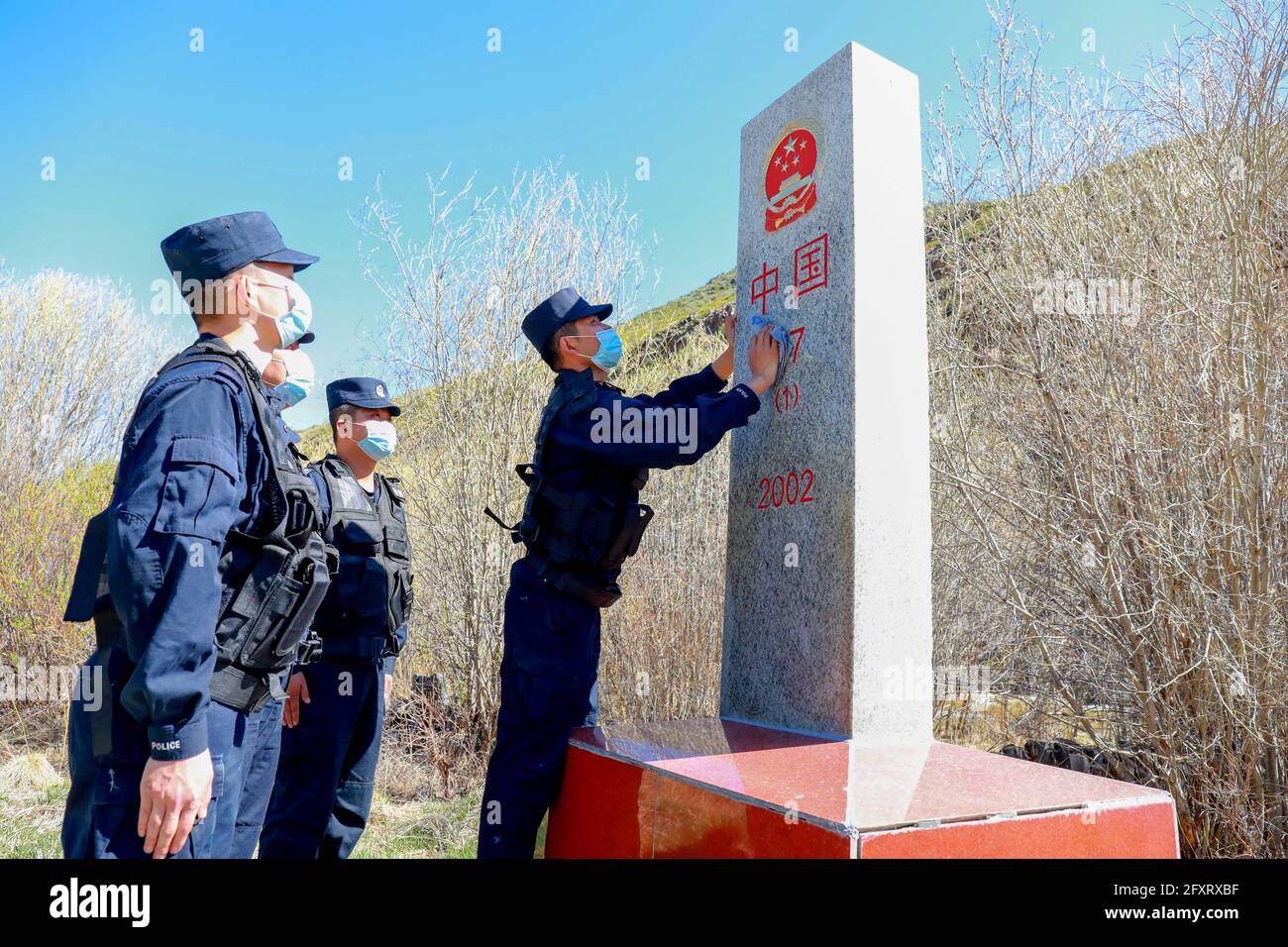 ALTAY, CHINA - MAY 27, 2021 - Police wipe boundary markers at the ...