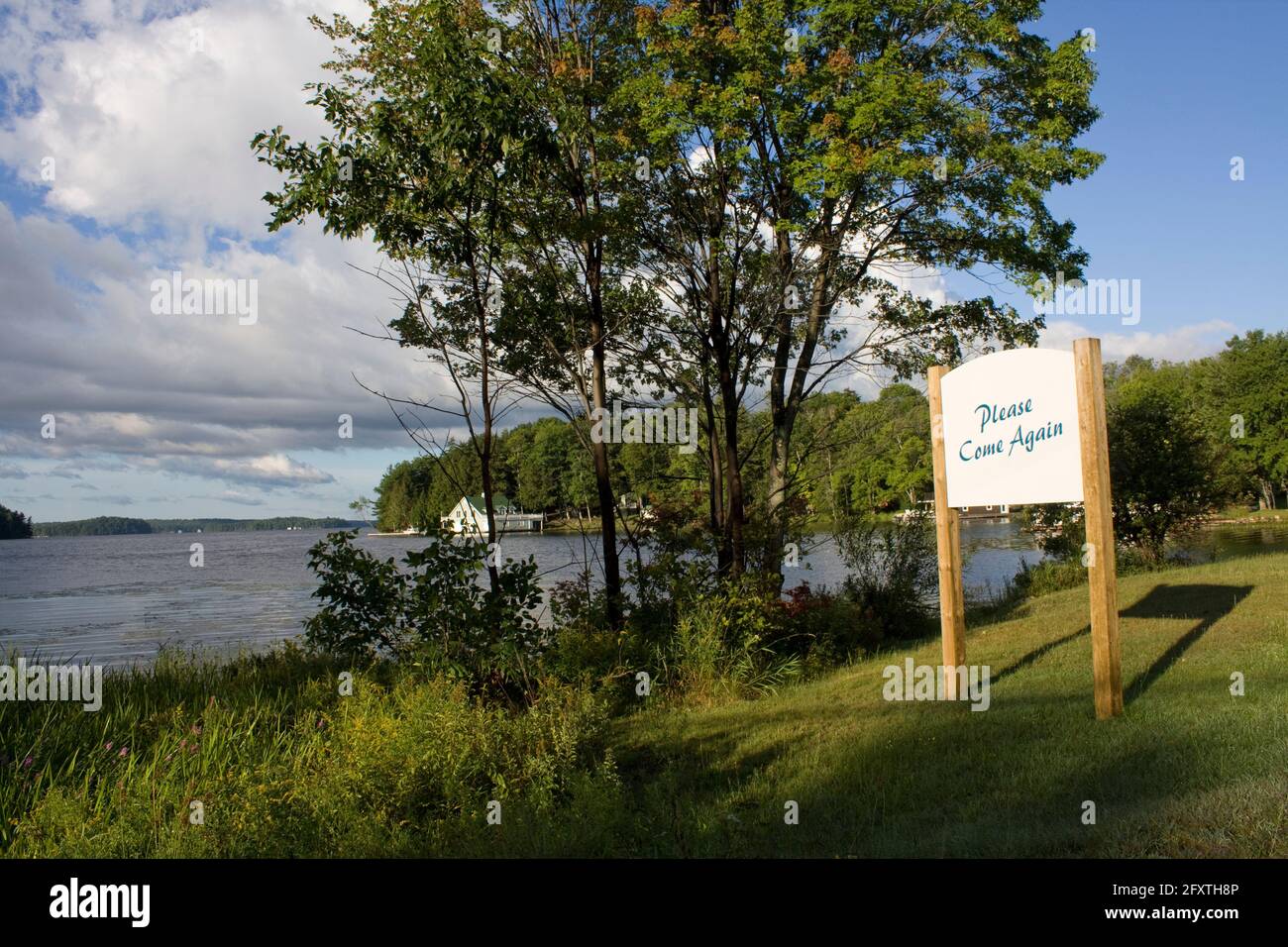 Sign overlooking calm lake water shot in Muskoka, Ontario Cottage ...