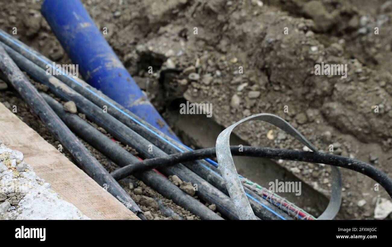 electric cables installed in the ground Stock Photo - Alamy