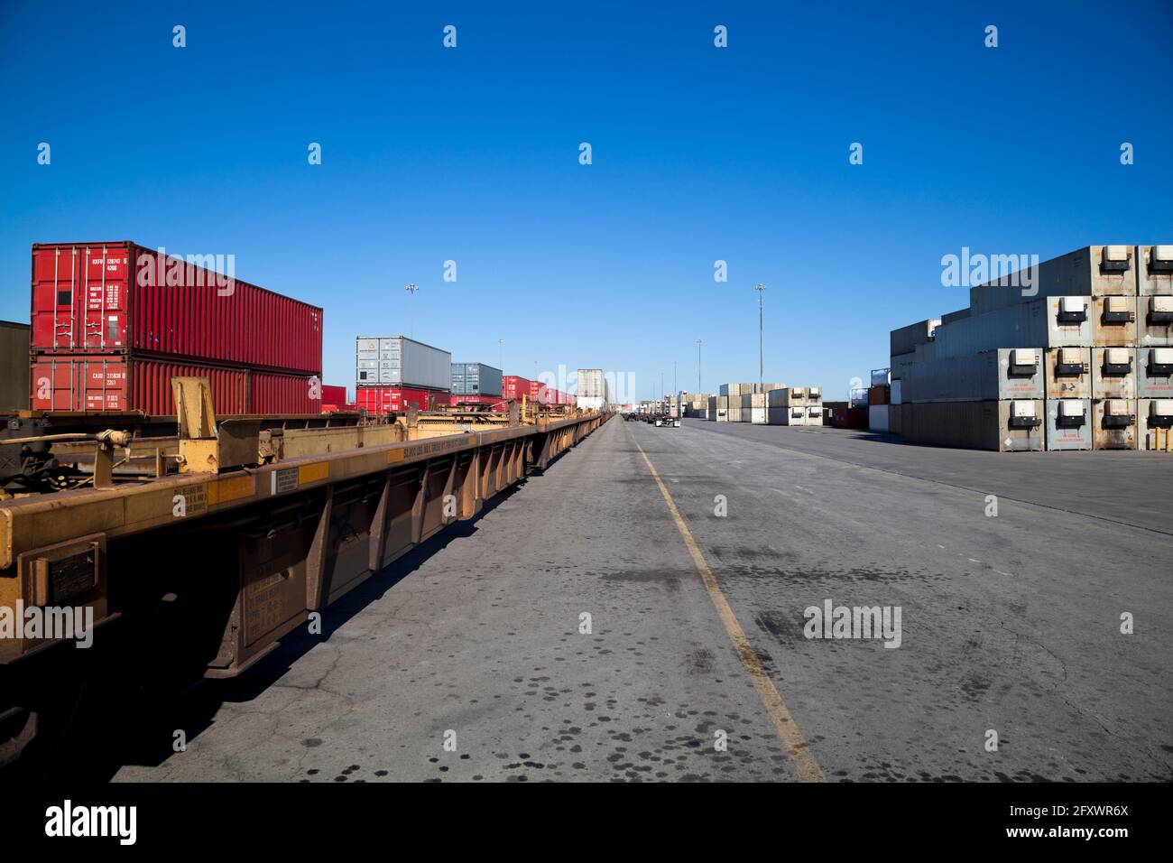 Rail yard with containers loaded onto train with flat deck trucks Stock ...