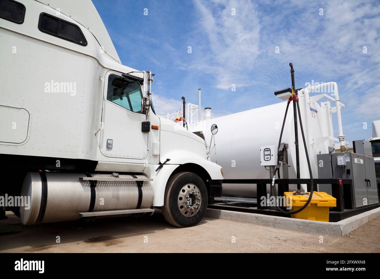 Diesel truck refueling station with transport truck parked in front of ...