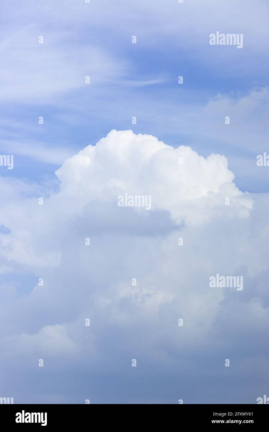 Top of a growing cumulus cloud rising through the several layers of the ...