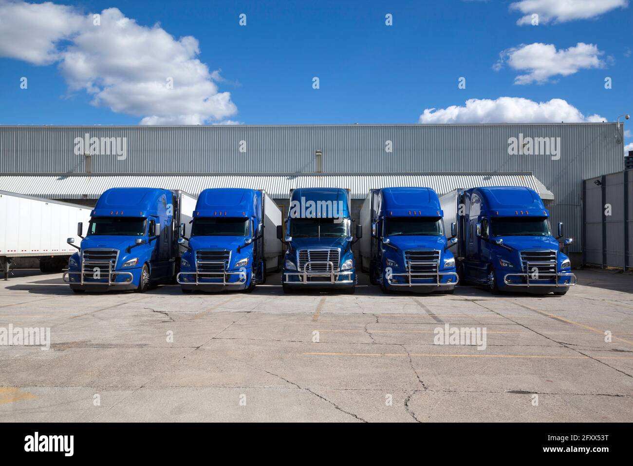 Blue Transport Trucks Lined Up in the Yard of a Warehouse Stock Photo ...