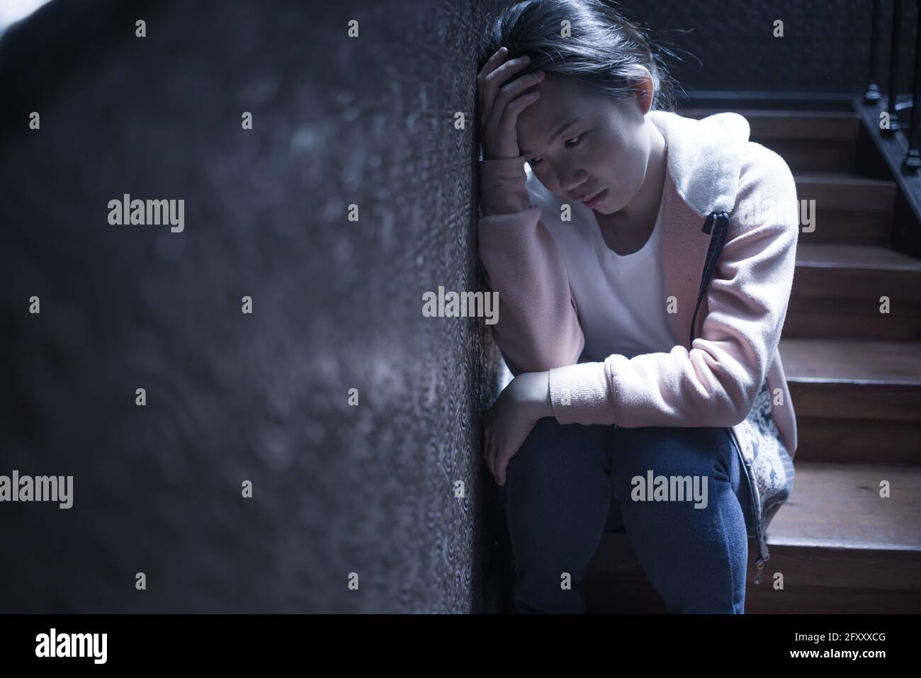 young beautiful Asian woman in pain suffering depression - dramatic ...