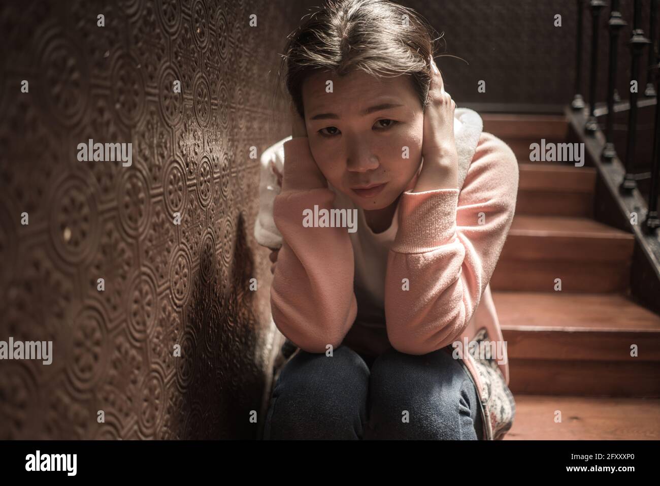 young beautiful Asian woman in pain suffering depression - dramatic ...