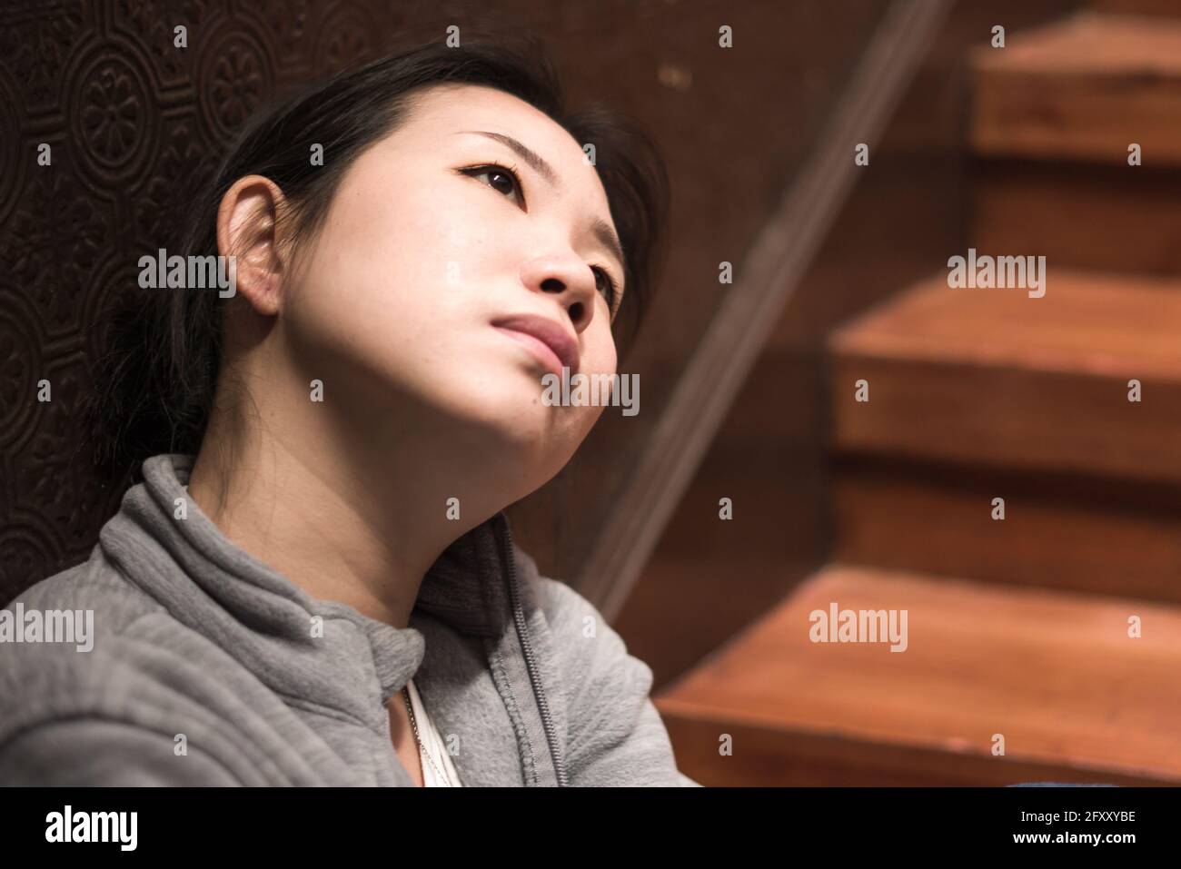 young beautiful Asian woman in pain suffering depression - dramatic ...