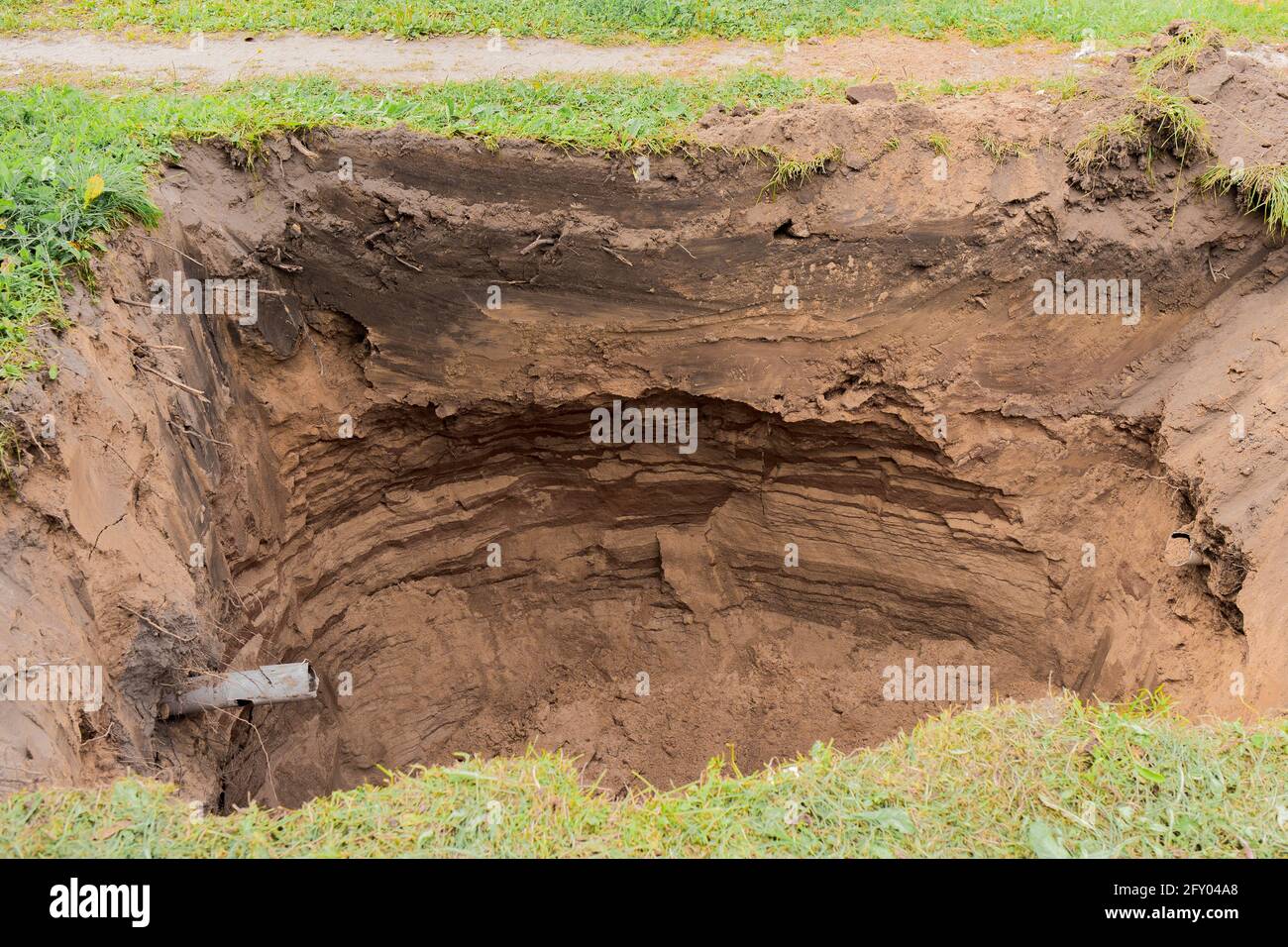 Deep pit in the ground for home sewers Stock Photo - Alamy