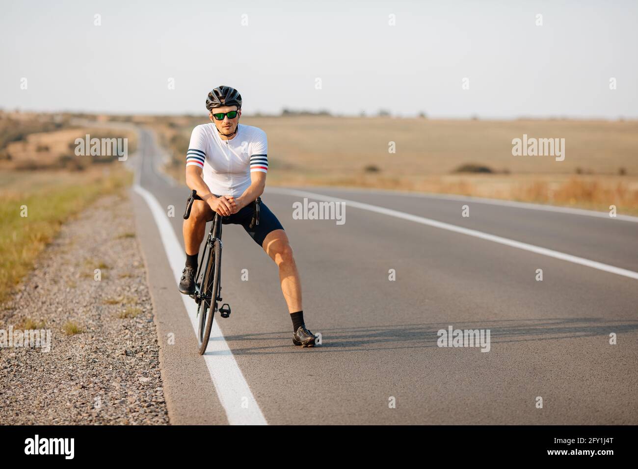 Handsome cyclist having break during morning ride outdoors Stock Photo ...