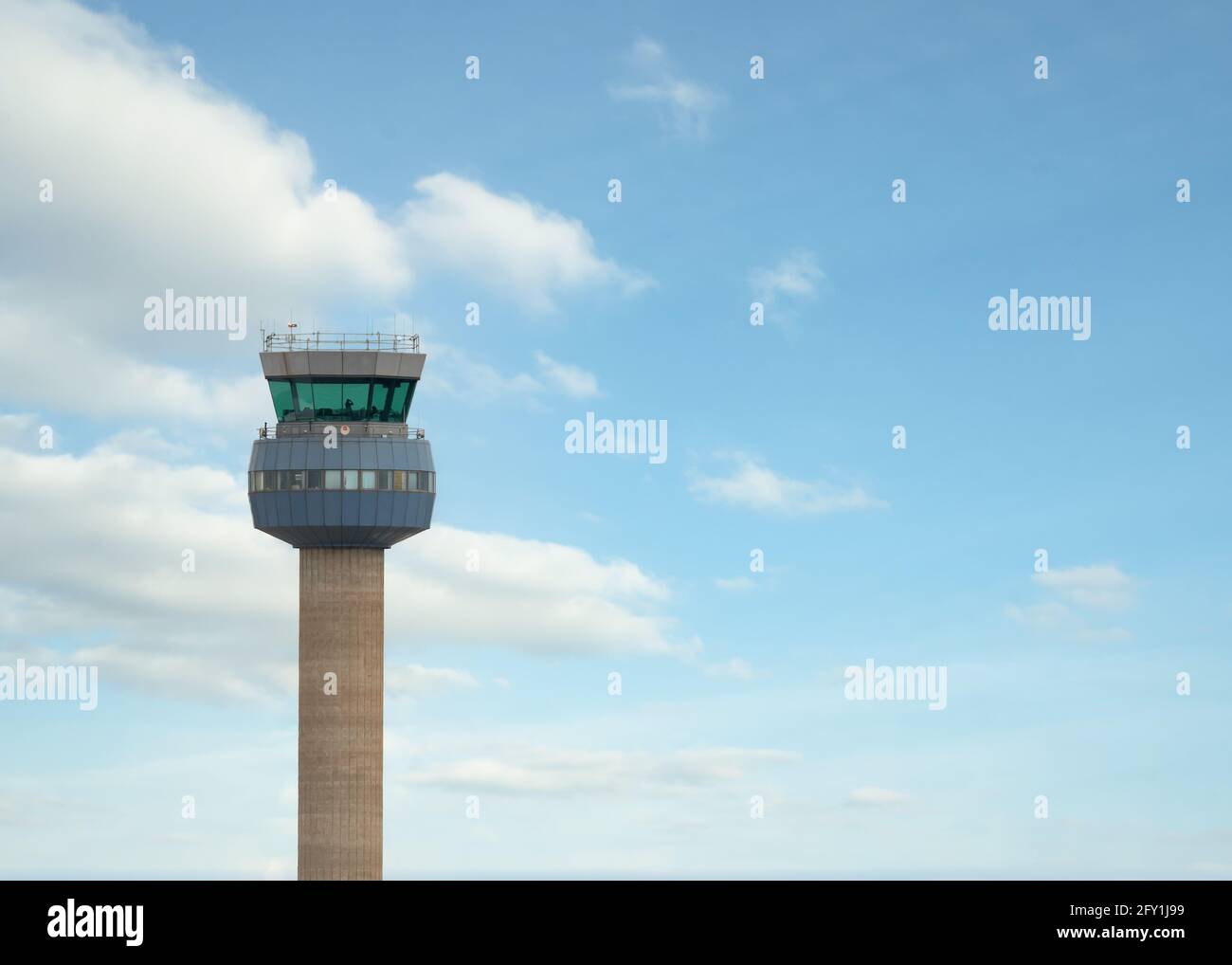 Airport traffic control tower on summer day with blue sky behind ...