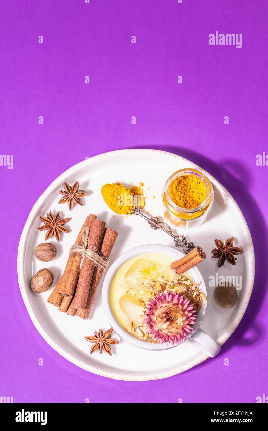 Golden turmeric milk with ice. Cinnamon, nutmeg, anise spices. Healthy ...