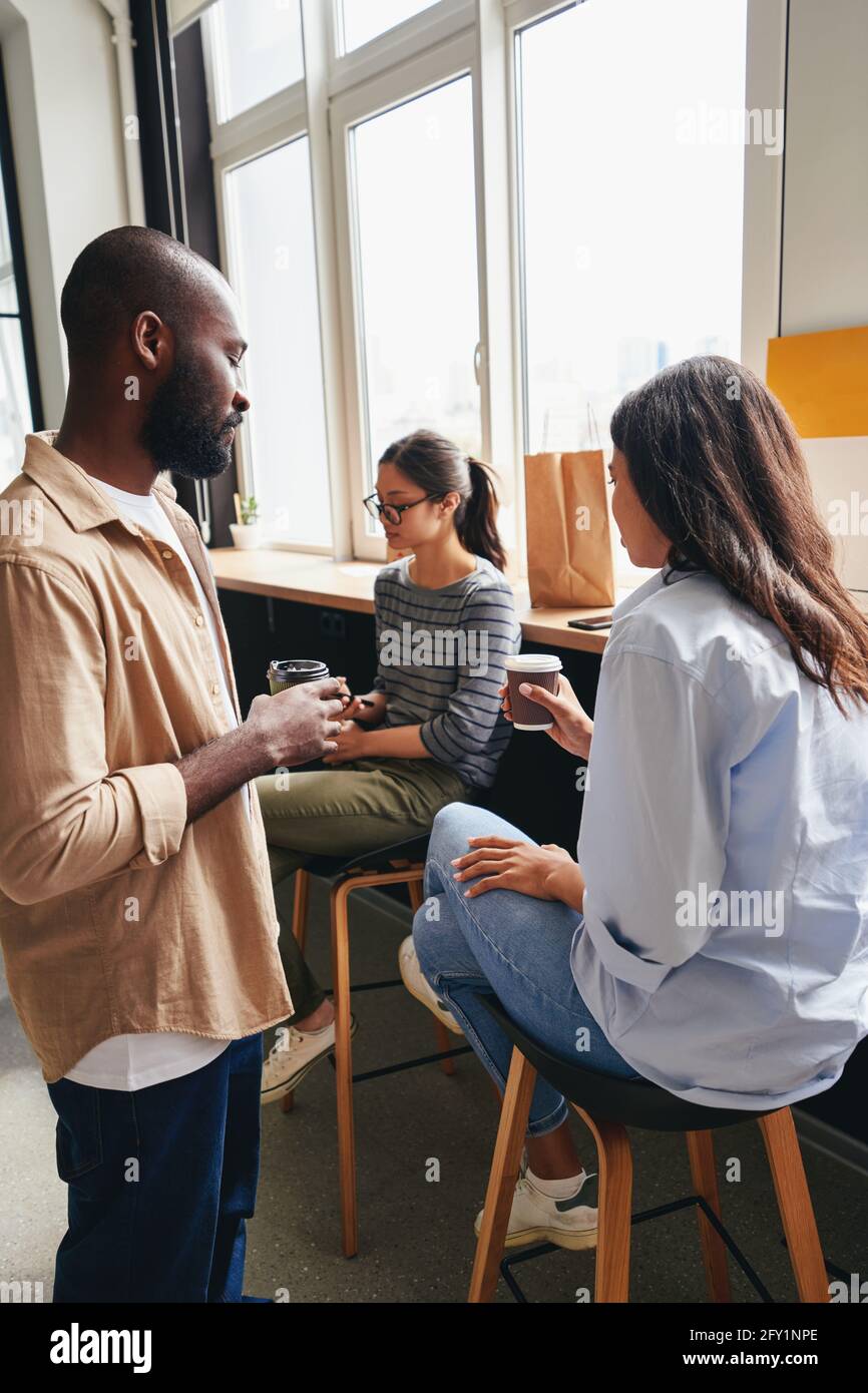 Three young colleagues having a coffee break together Stock Photo - Alamy